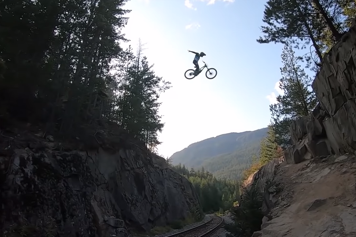 Mountain Biker Leaps Over Moving Freight Train