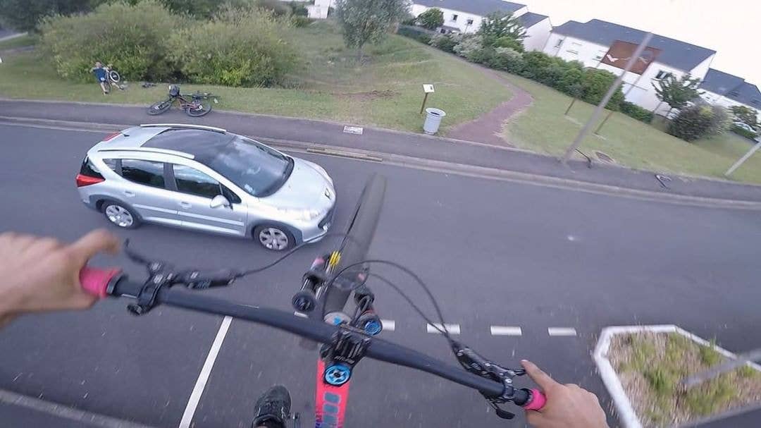 Mountain Biker Illegally Jumps Over Moving Car