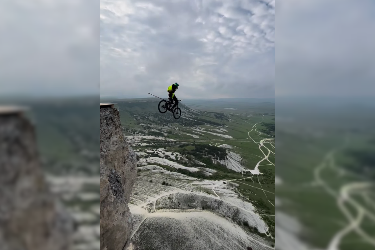 Rider Launches Off Towering Cliff With Parachute