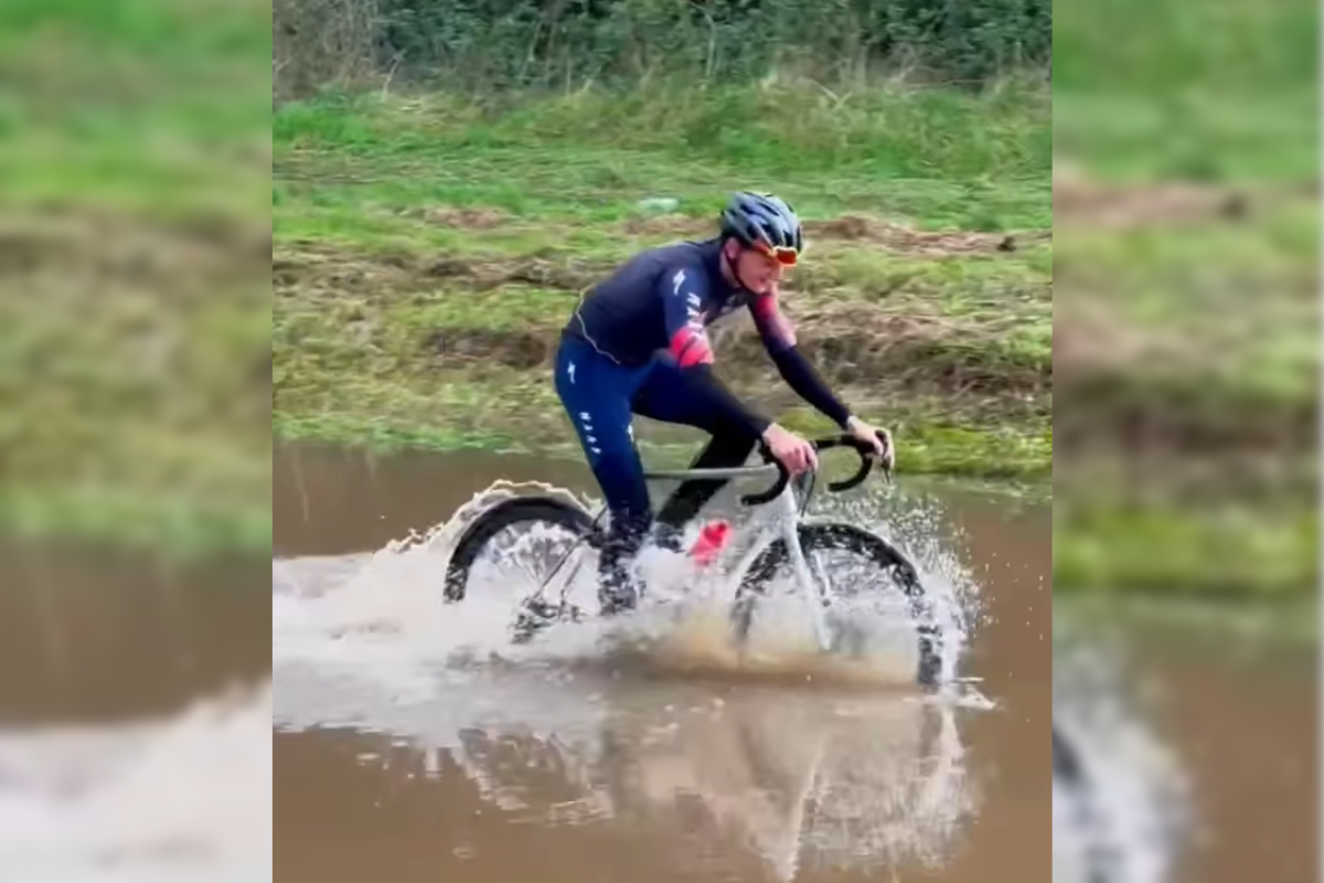 Powerful Cyclist Blasts Through Puddle While Fellow Riders Walk